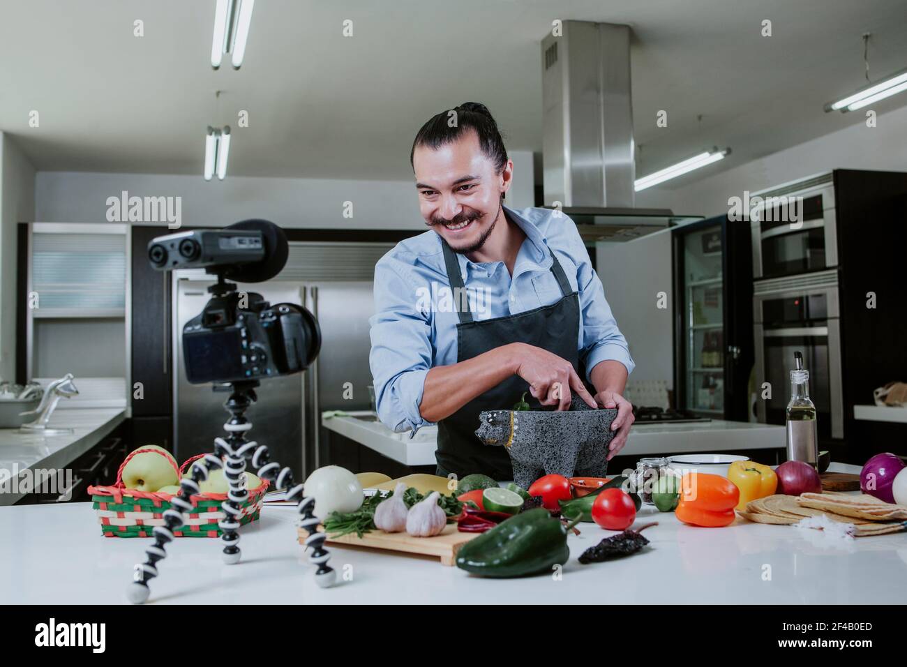 latin man food blogger preparing mexican sauce, cooking and culinary ...