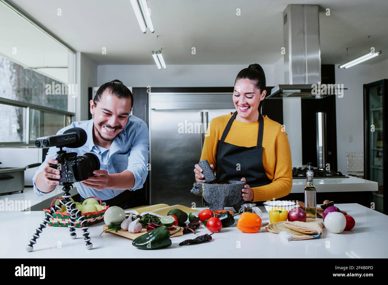 latin couple blogger vlogger and online influencer recording video ...