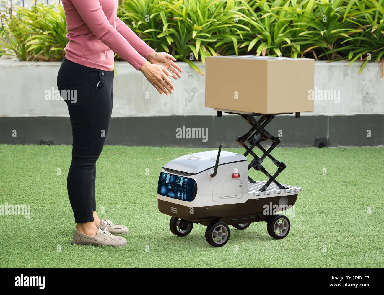 Delivery robot send cardboard box to customer Stock Photo - Alamy