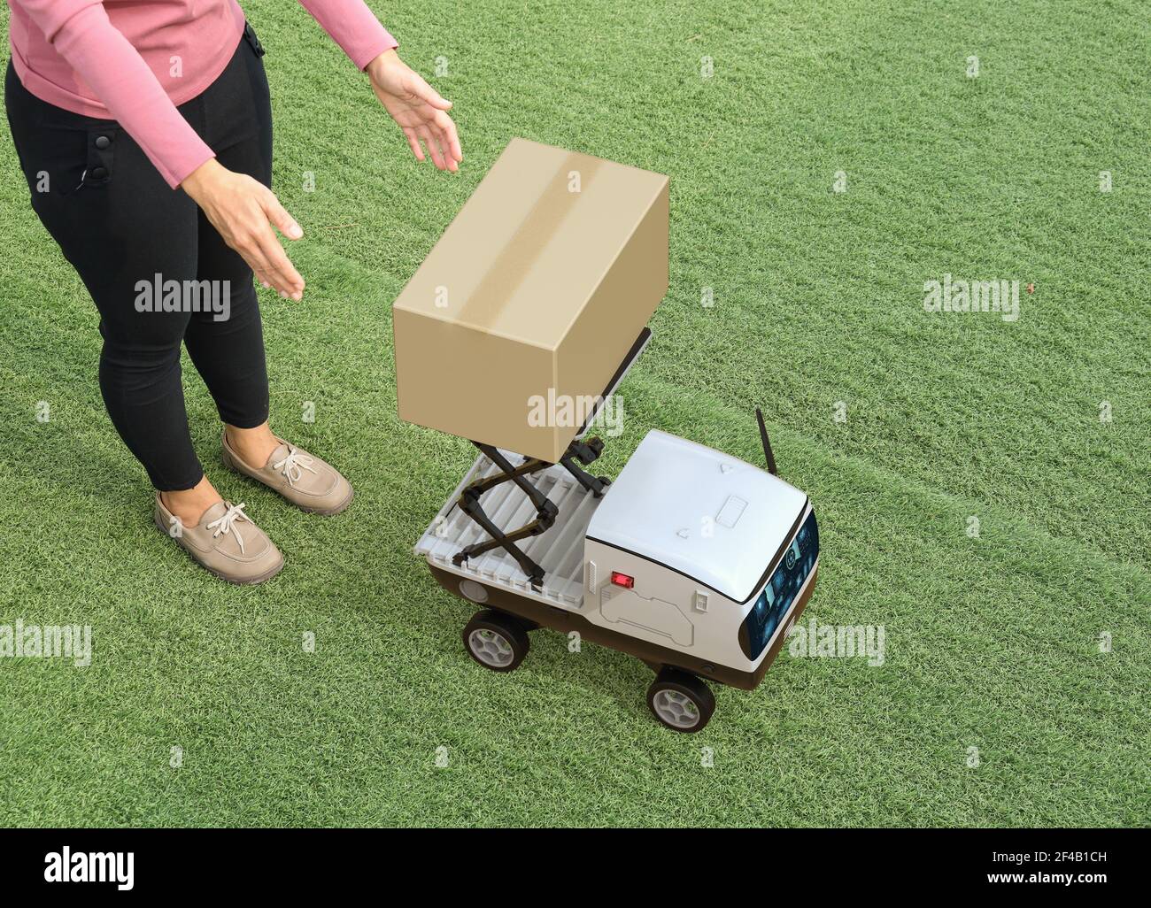 Delivery robot send cardboard box to customer Stock Photo - Alamy