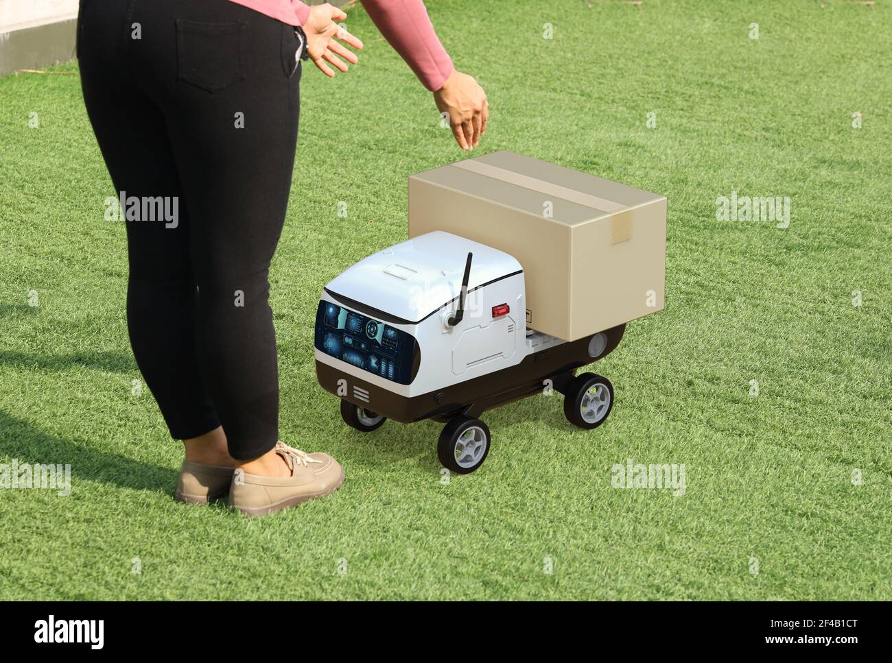 Delivery robot send cardboard box to customer Stock Photo - Alamy