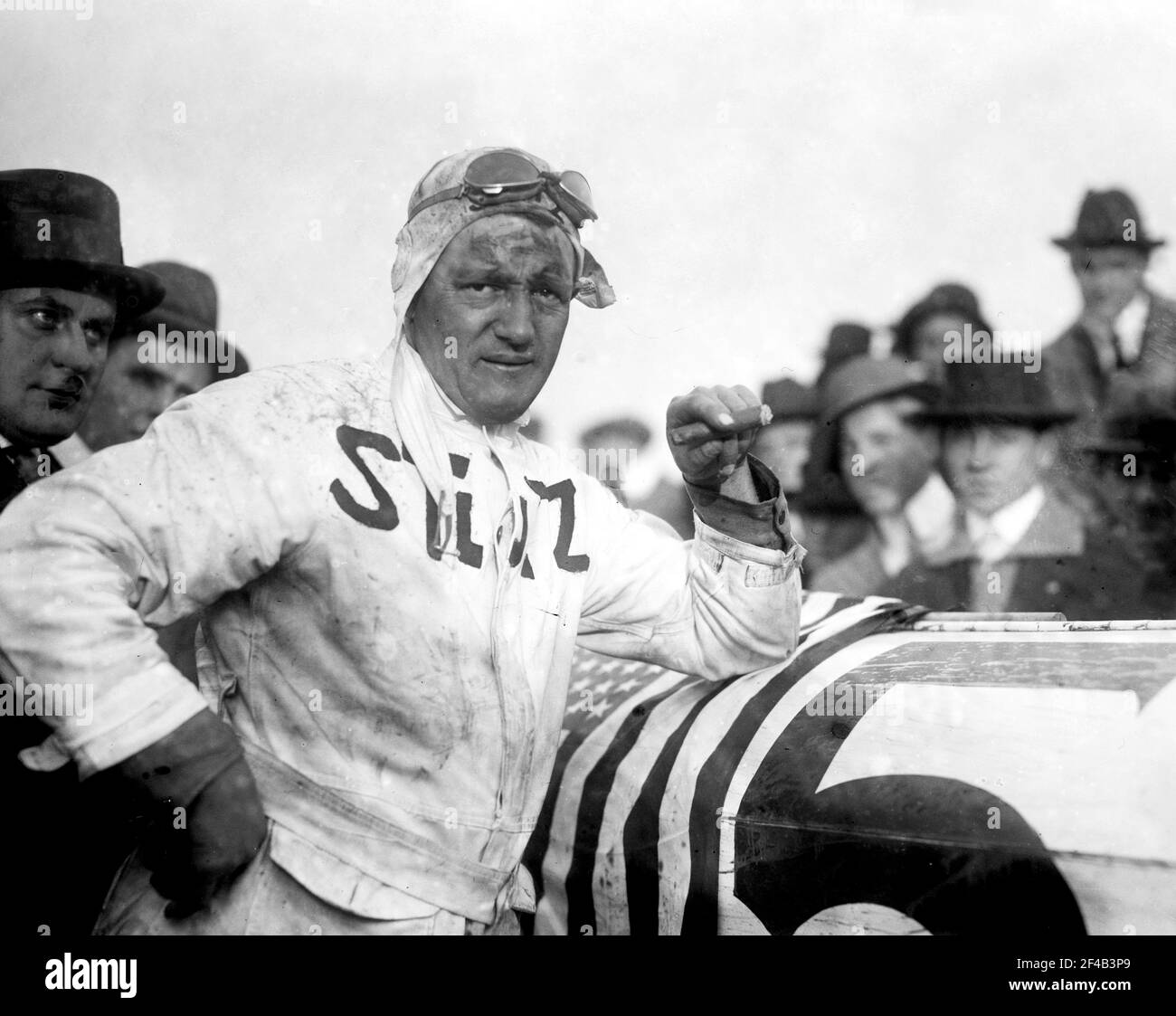 Photograph shows racecar driver Gil Andersen standing next to his Stutz ...