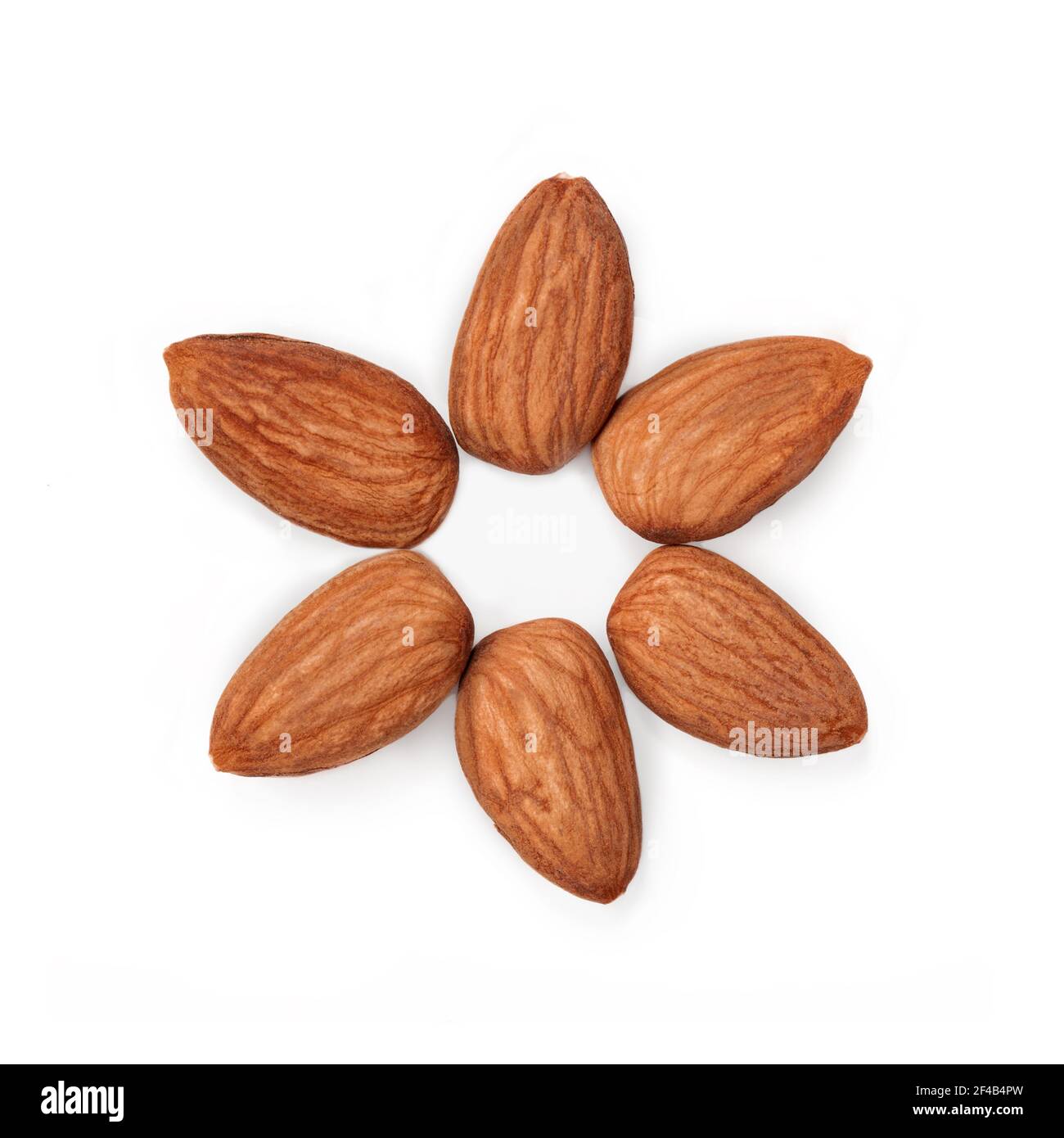 Single almond flower. 6 raw almonds arranged in a shape of a flower ...