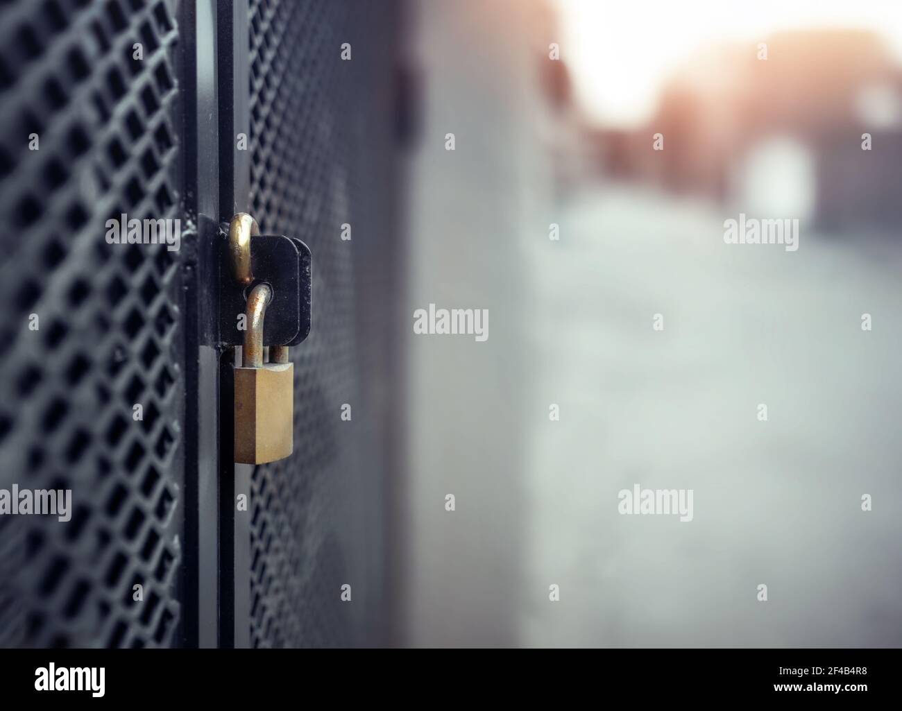 Padlock on outdoor door, close up. Caged in commercial or residential ...