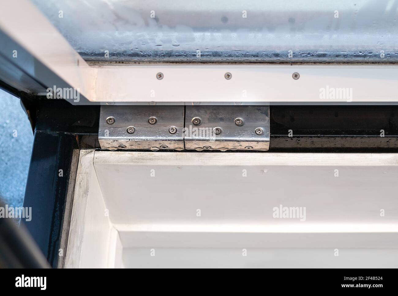 Leaky rooftop hatch or skylight. Visible moisture accumulation on door ...