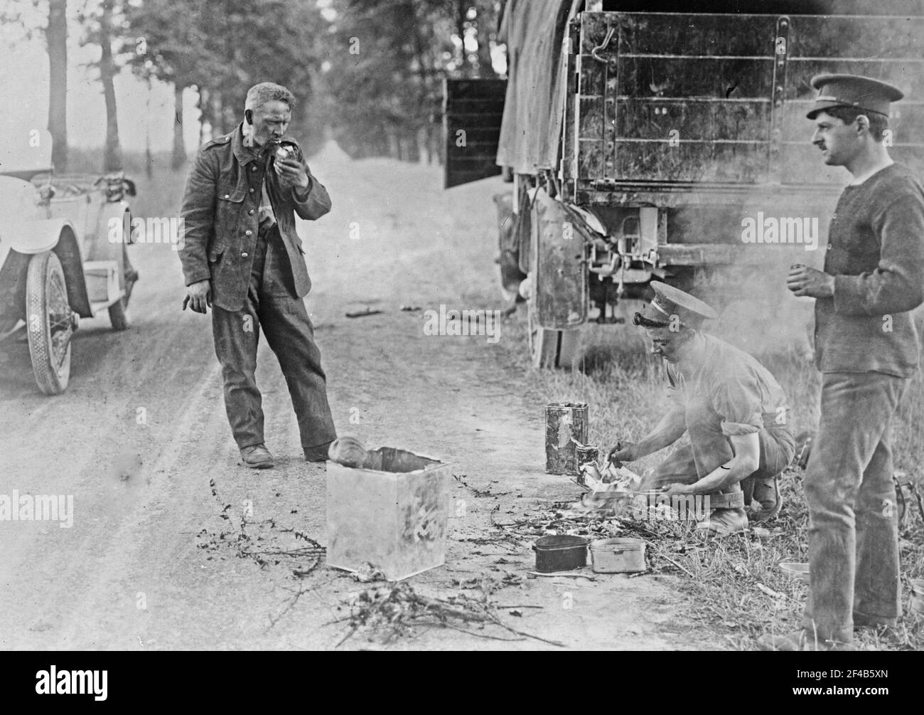 English soldiers cooking and eating next to a truck on the road, during ...