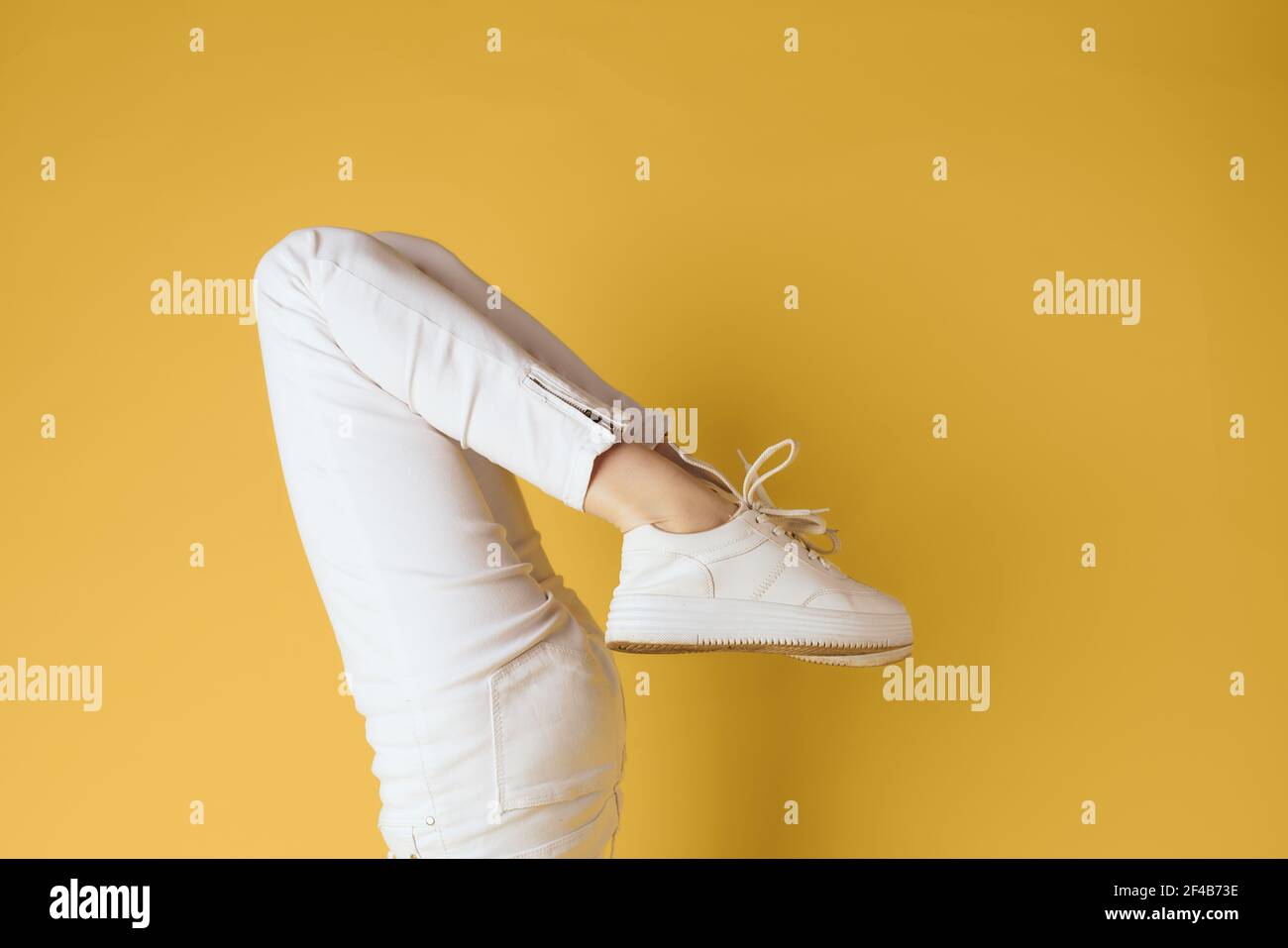 Inverted womens legs sneakers fashion studio street style Stock Photo ...