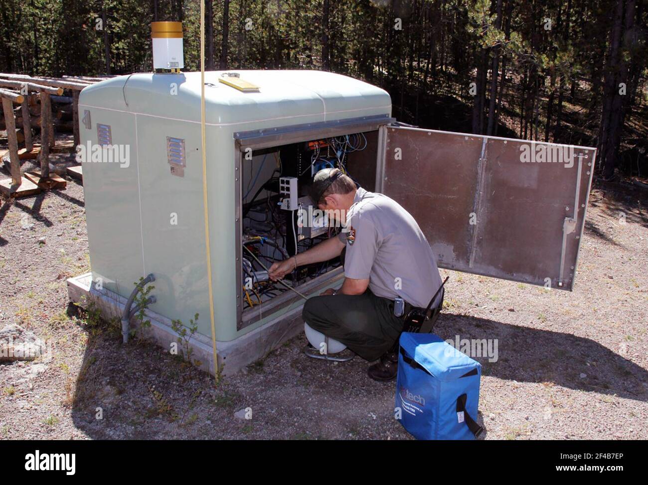 National Park Service employee inspects a Plate Boundary Observatory ...