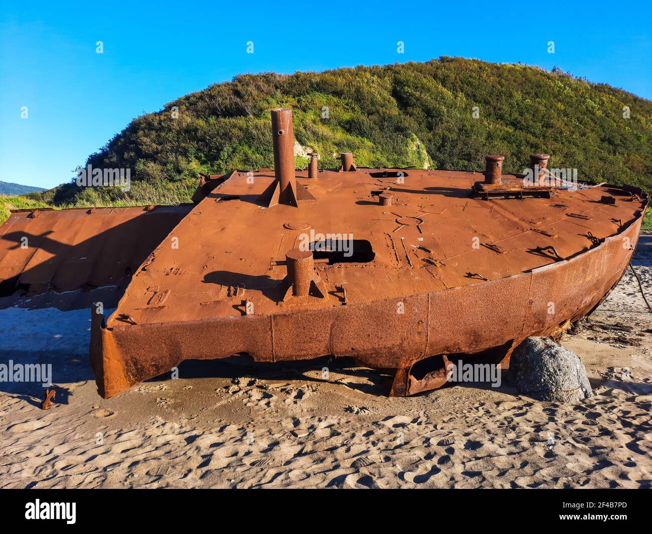 An old rusty ship thrown out on the seashore Stock Photo - Alamy