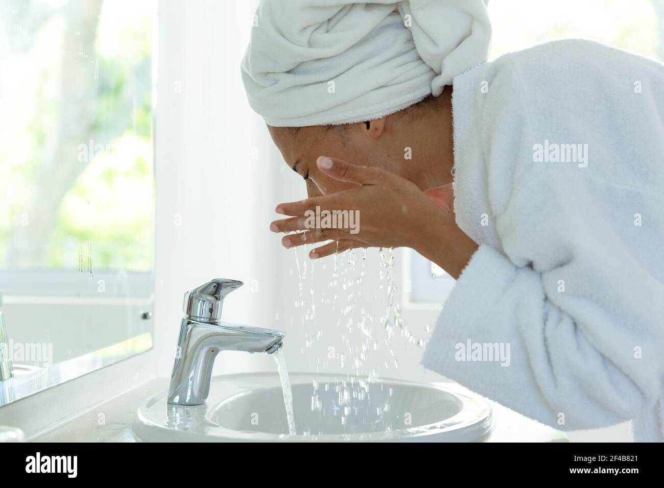Woman washing her face in bathroom hi-res stock photography and images ...