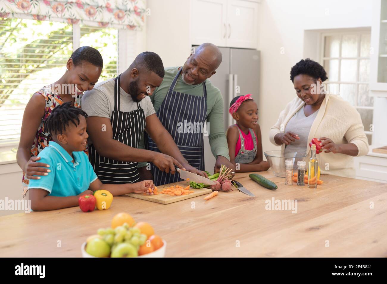 Happy african american parents cooking with son and daughter and ...