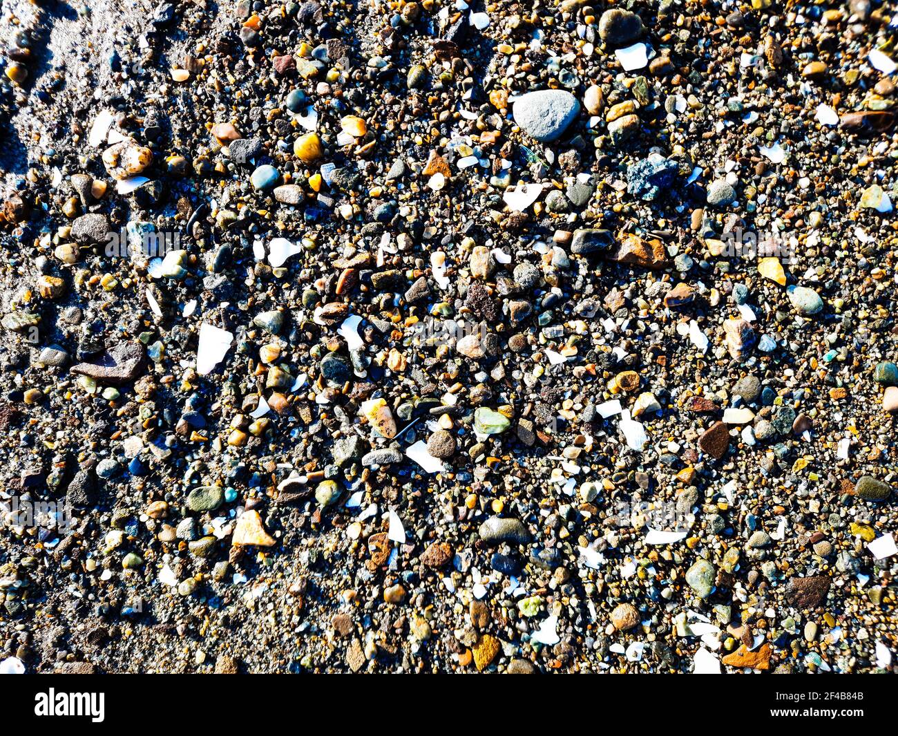 Rocky beach. Small multi-colored stones. Pebbles Stock Photo - Alamy