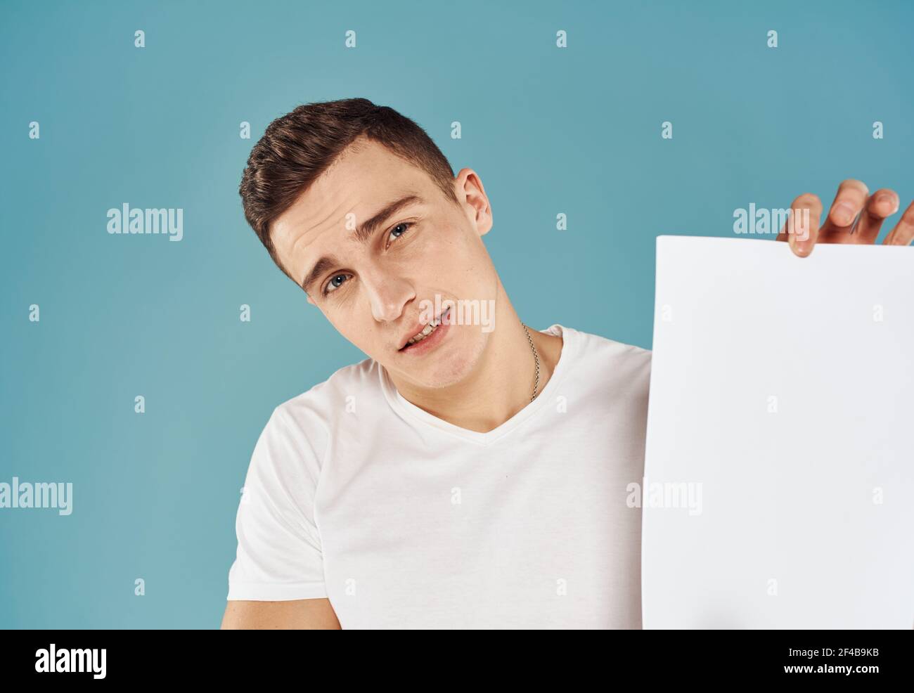 Man Holding Flyer Poster mockup blue background cropped view Stock ...