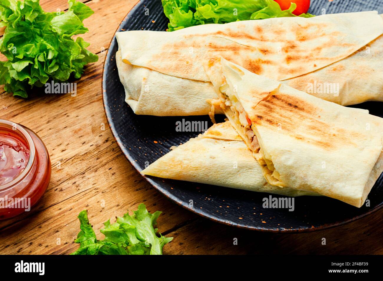 Chicken shawarma made from roasted meat wrapped in pita bread.Doner ...