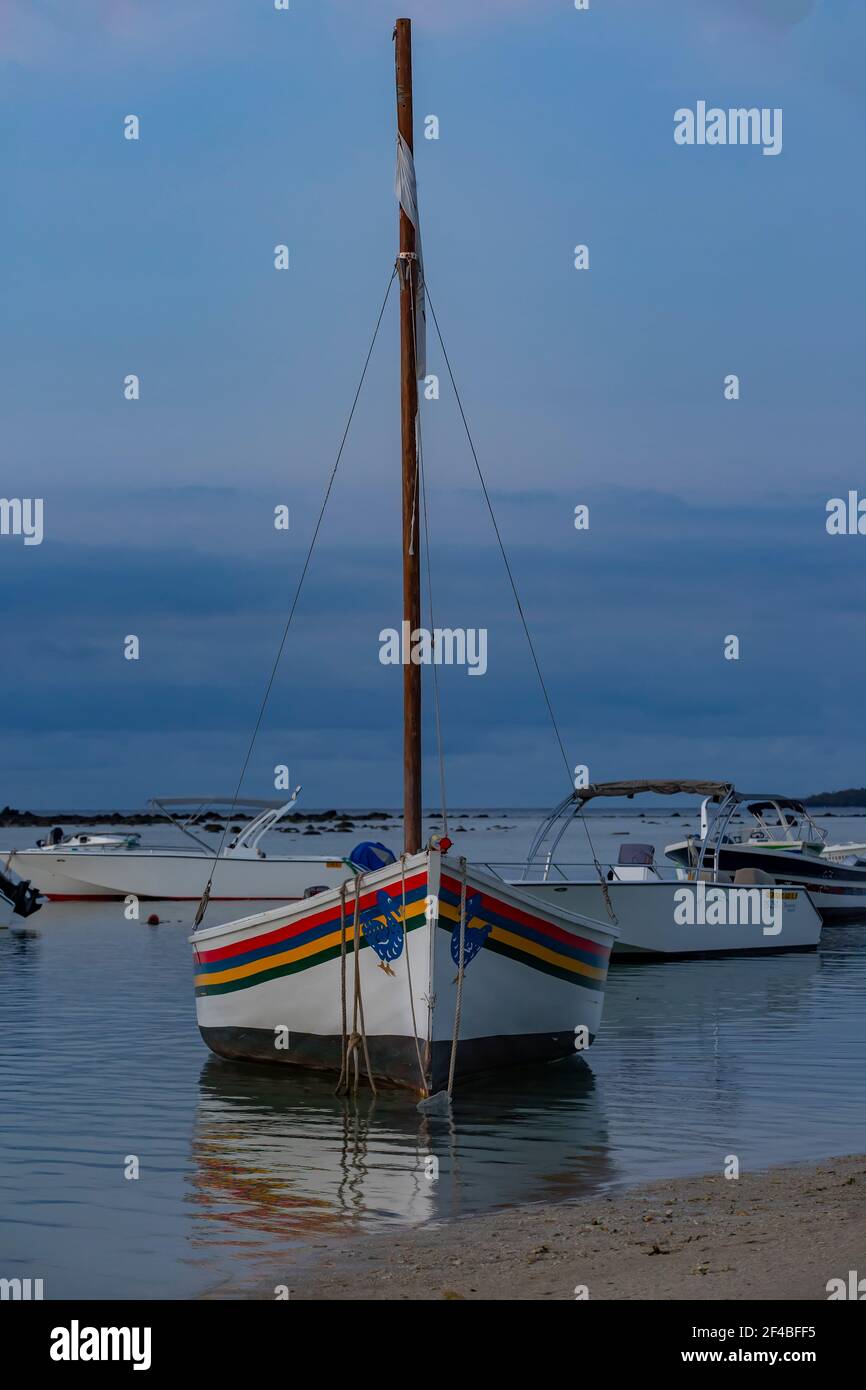 fishing boat at Blue hour on the public beach of Flic en Flac ...