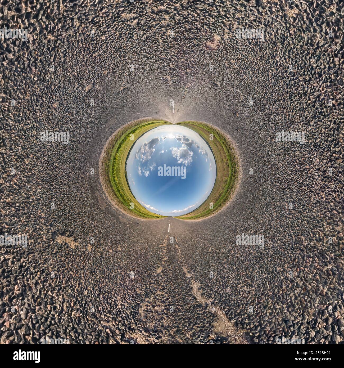 blue sky ball in middle of swirling asphalt road or field. Inversion of ...