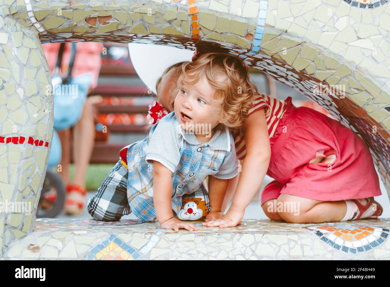 Two funny kids are playing, covering his face with his hands Stock ...