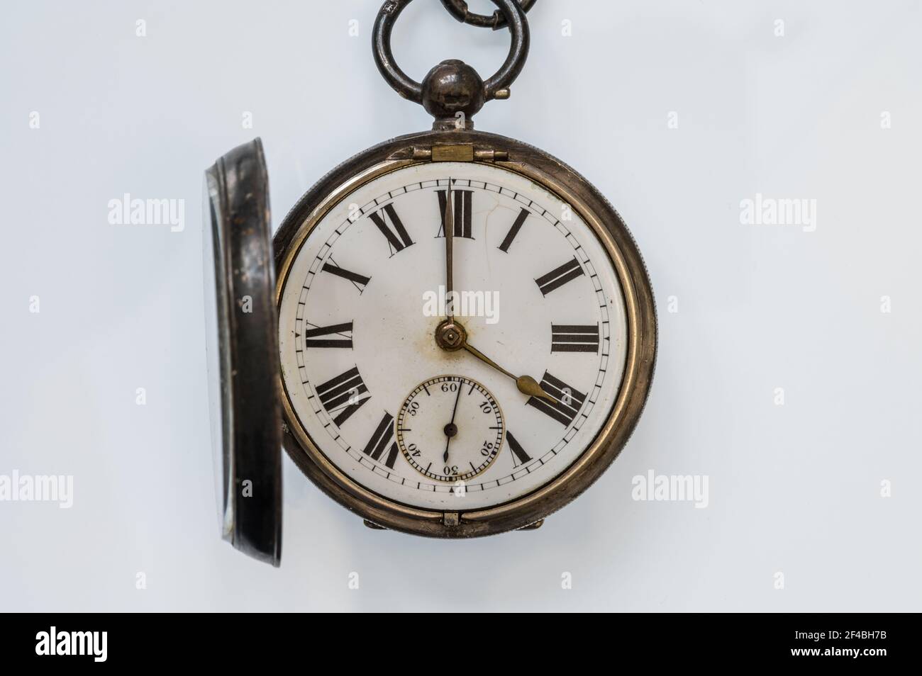 Antique pocket watch with roman numerals and the front glass open, on a ...