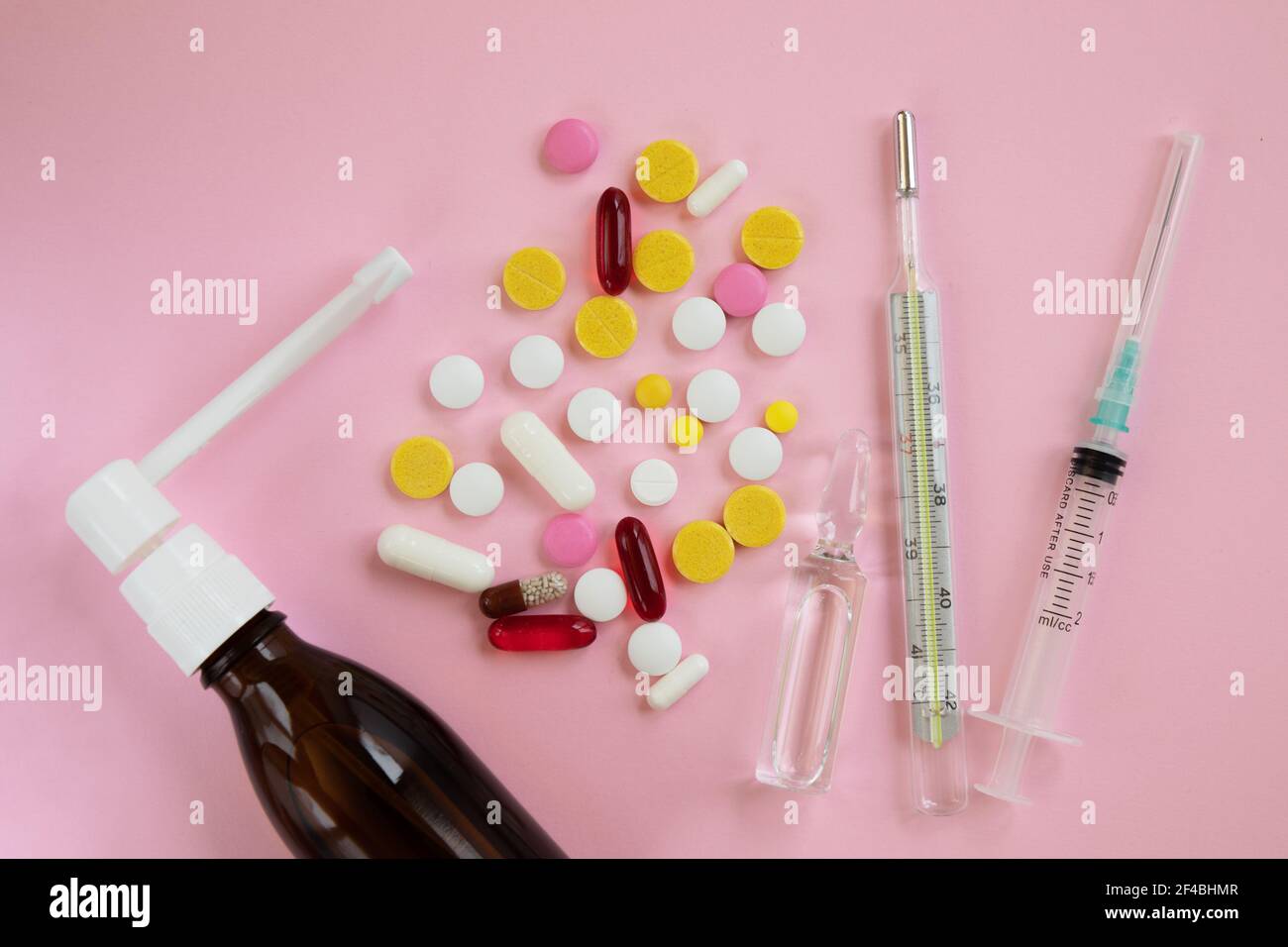 Glass Bottle with medicines. Thermometer, syringe and pill to treat ...