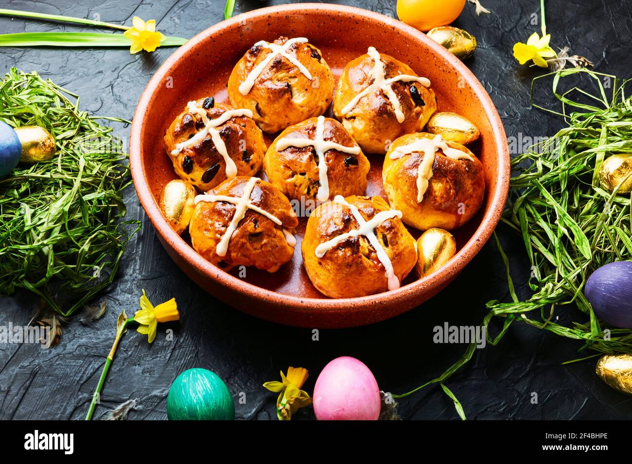 Easter hot cross buns and holiday decor.Traditional English Easter buns ...
