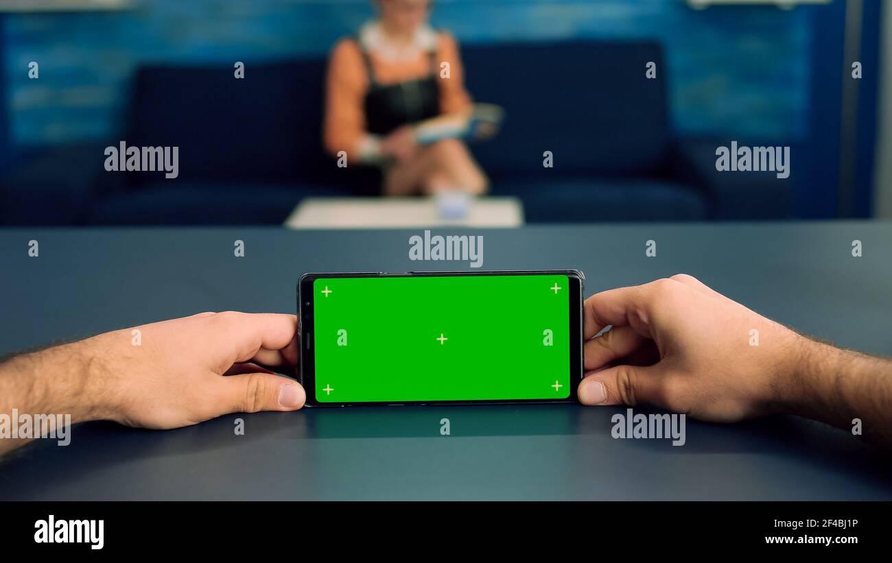 Pov of man hands holding in horizontal mode smartphone with mock up ...