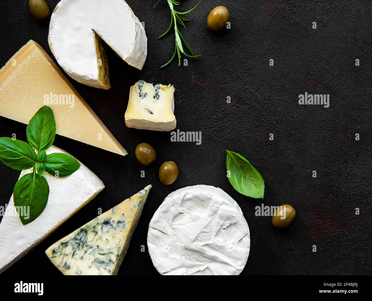 Various types of cheese on a black concrete background Stock Photo - Alamy