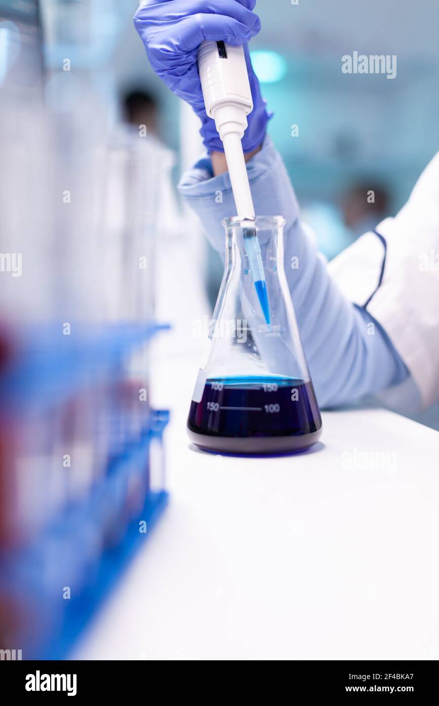 Closeup research of medical scientist working with micropipette ...