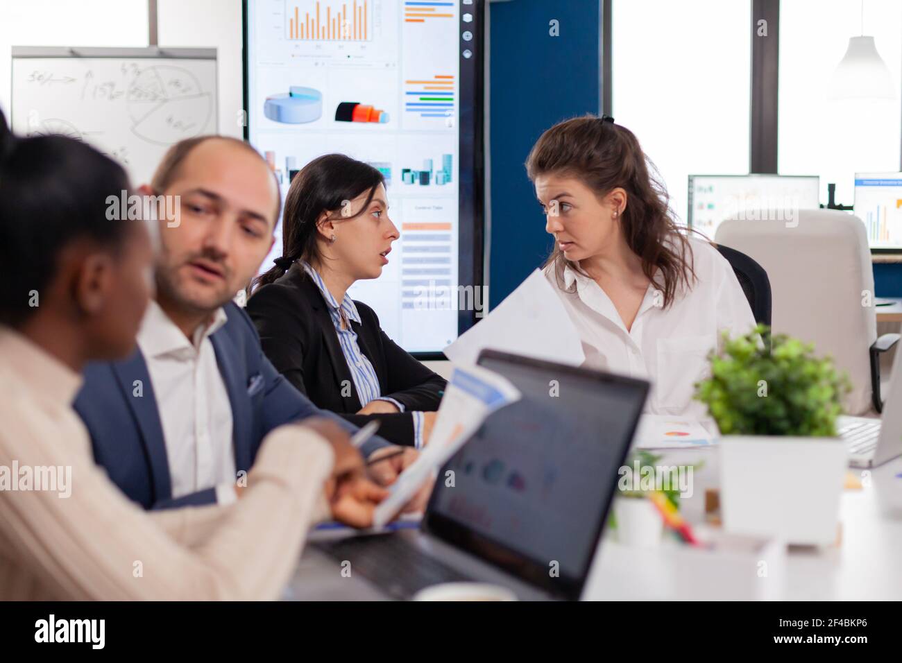 Women in startup office having a conversation in conference meeting ...