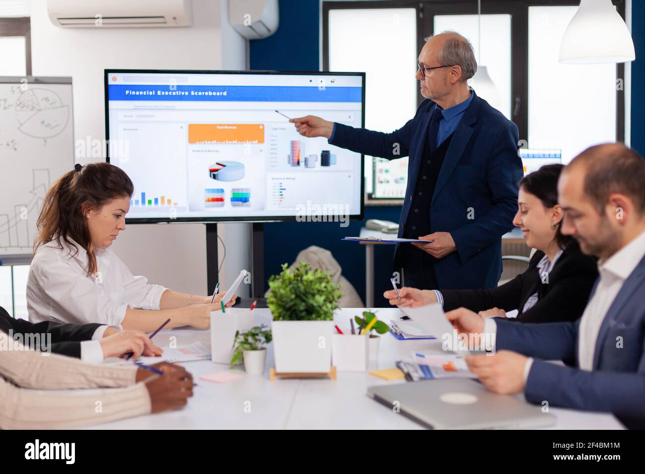 Senior team leader explaining presentation discussion in conference ...