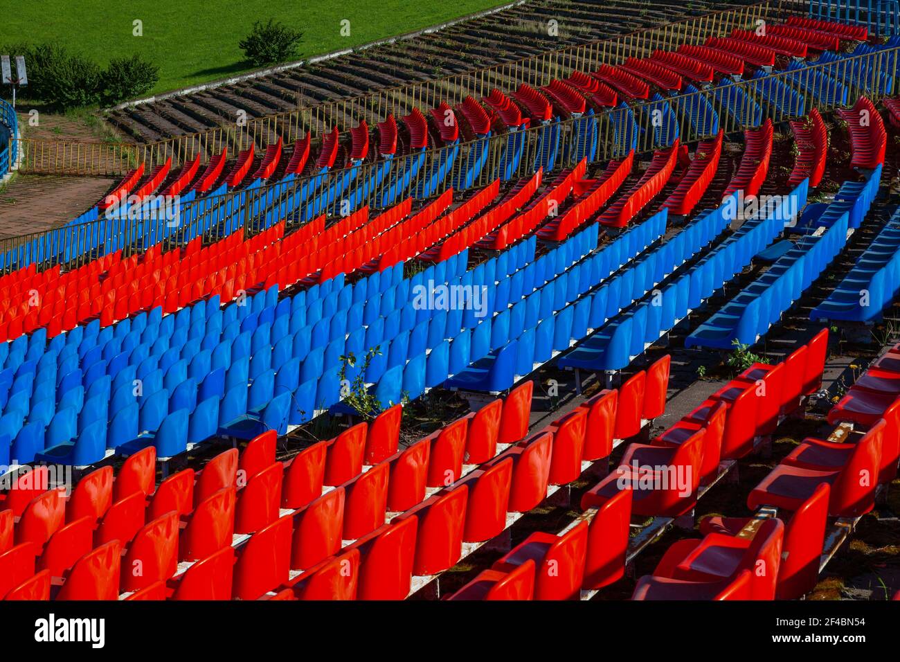 The stands of the old football stadium with rows of plastic seats in ...