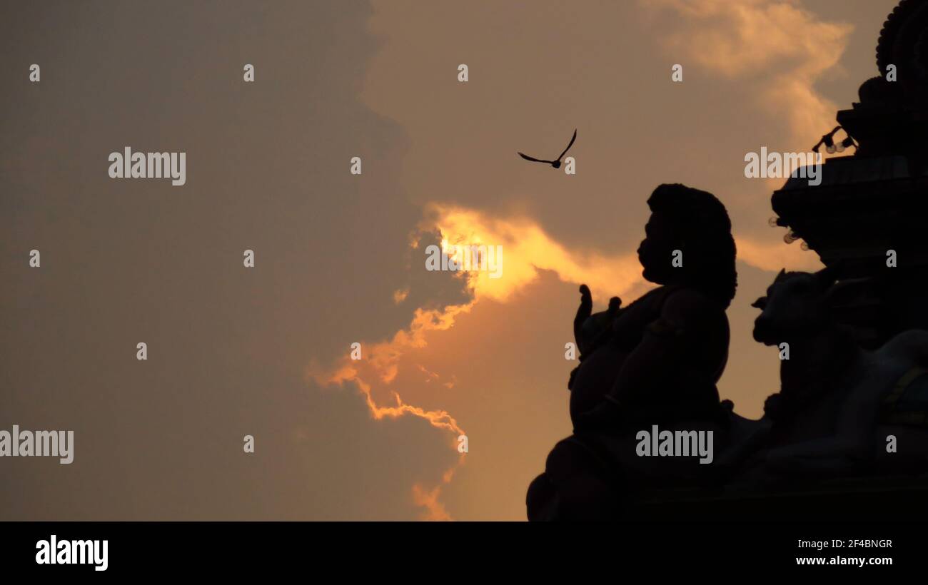 Hindu Statues In Silhouette At Sunset : Religious statues at Batu Caves ...