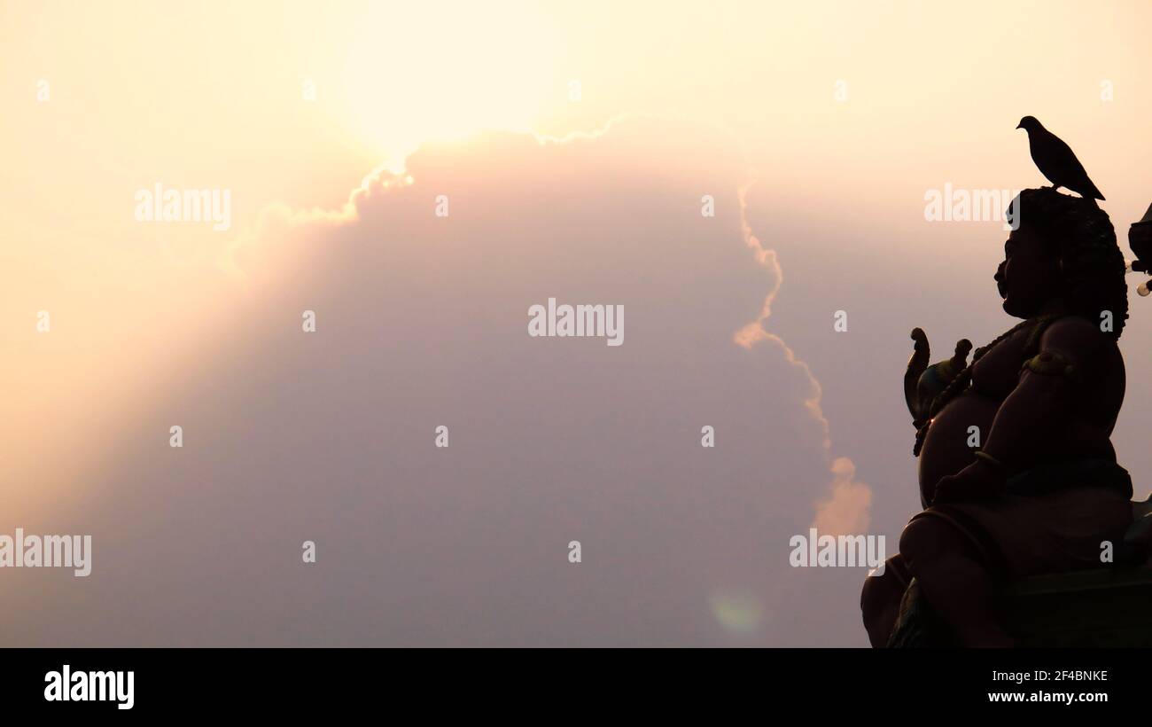 Hindu Statues In Silhouette At Sunset : Religious statues at Batu Caves ...