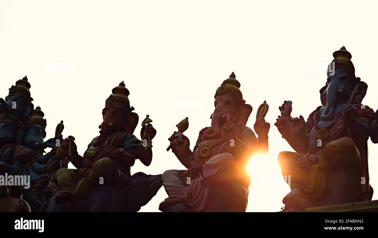 Hindu Statues In Silhouette At Sunset : Religious statues at Batu Caves ...