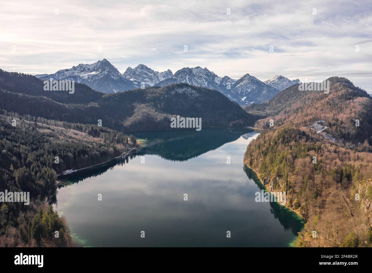 Aerial drone shot of Alpsee lake in Fussen with view of Alps snow ...