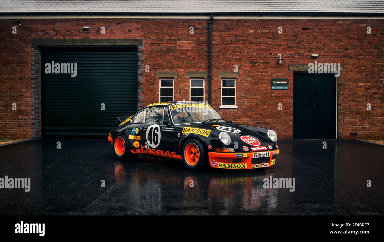 Black with racing livery classic Porsche 911 sports car attending a car ...