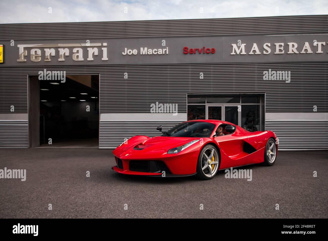 Red Ferrari LaFerrari modern supercar driven at a service center for ...