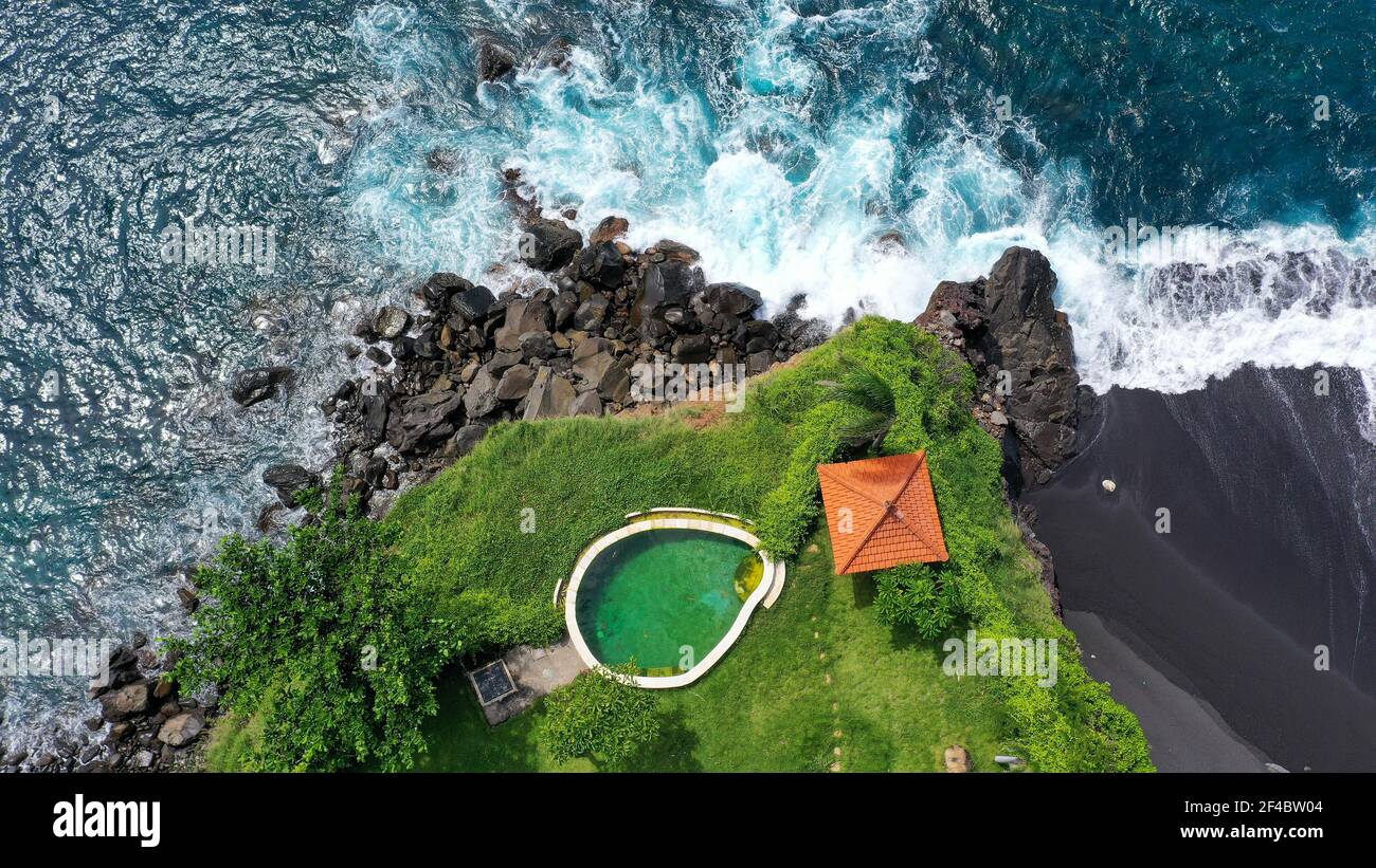 Top view of swimming pool on the cliff edge with the view of the ocean ...