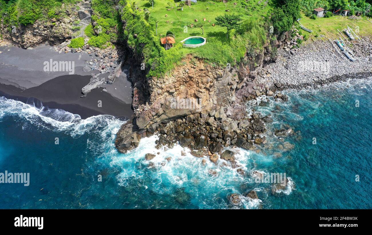 Aerial drone view to villa with swimming pool on the rocky coast in ...