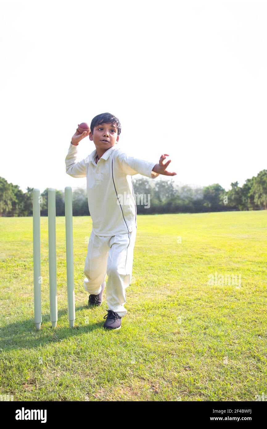 Young boy bowling leg spin in a cricket Stock Photo - Alamy