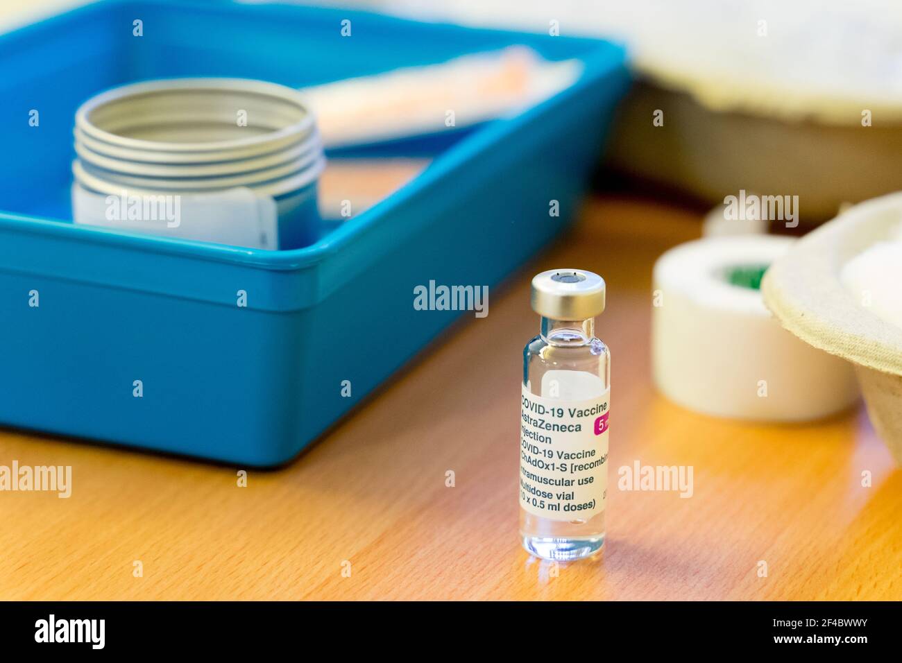 AstraZeneca vaccine in 5ml bottle on desk next to medicine tray for ...