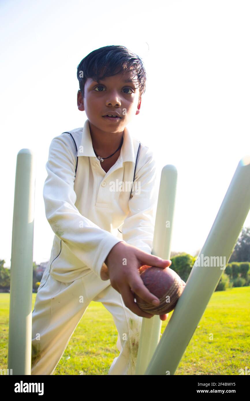 a boy fielding on the grounds during cricket game Stock Photo - Alamy