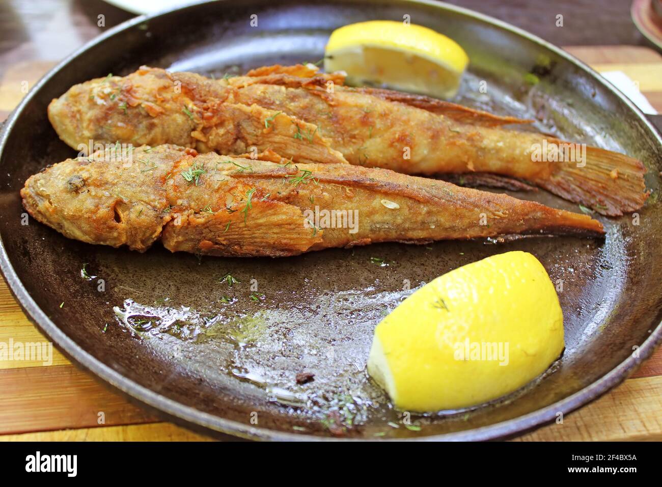 Fried mullet fish Stock Photo - Alamy