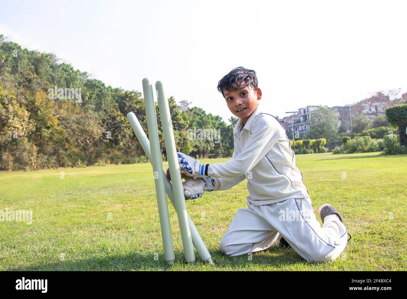 a boy fielding on the grounds during cricket game Stock Photo - Alamy