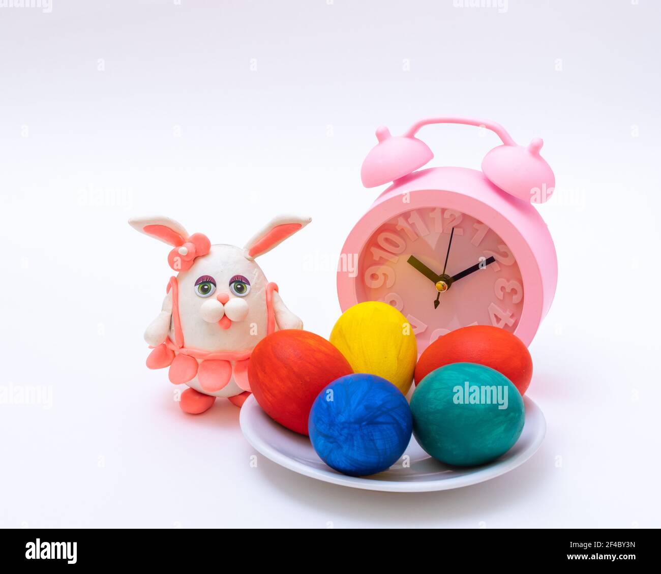 Easter breakfast concept. Hand-painted Easter eggs, alarm clock and ...