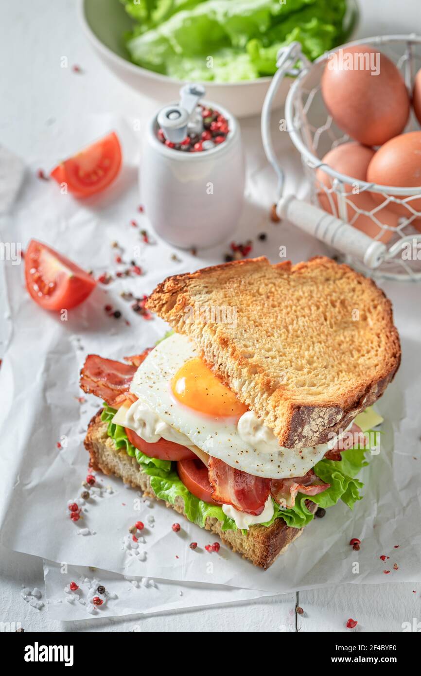Homemade sandwich with bacon, egg and mayonnaise. British breakfast ...