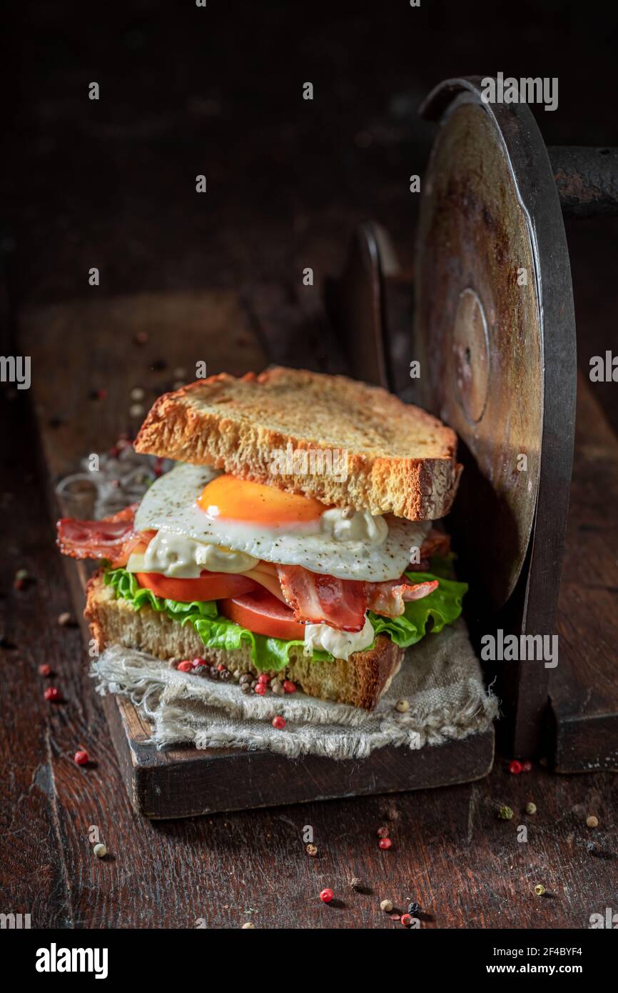 Homemade sandwich with egg, vegetables and bacon. British breakfast ...