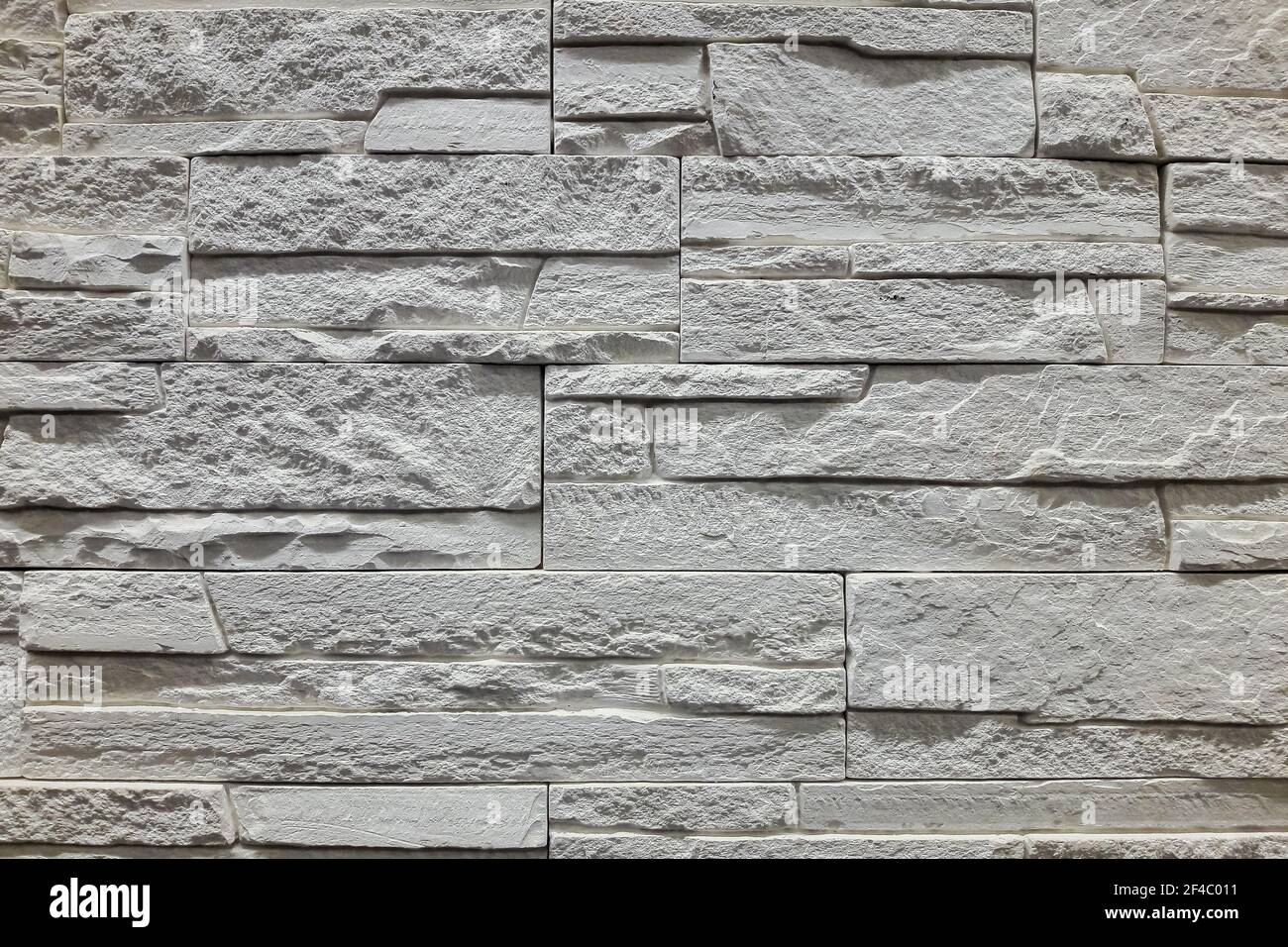 The wall is made of multi-layered natural stone. Stone for building a ...