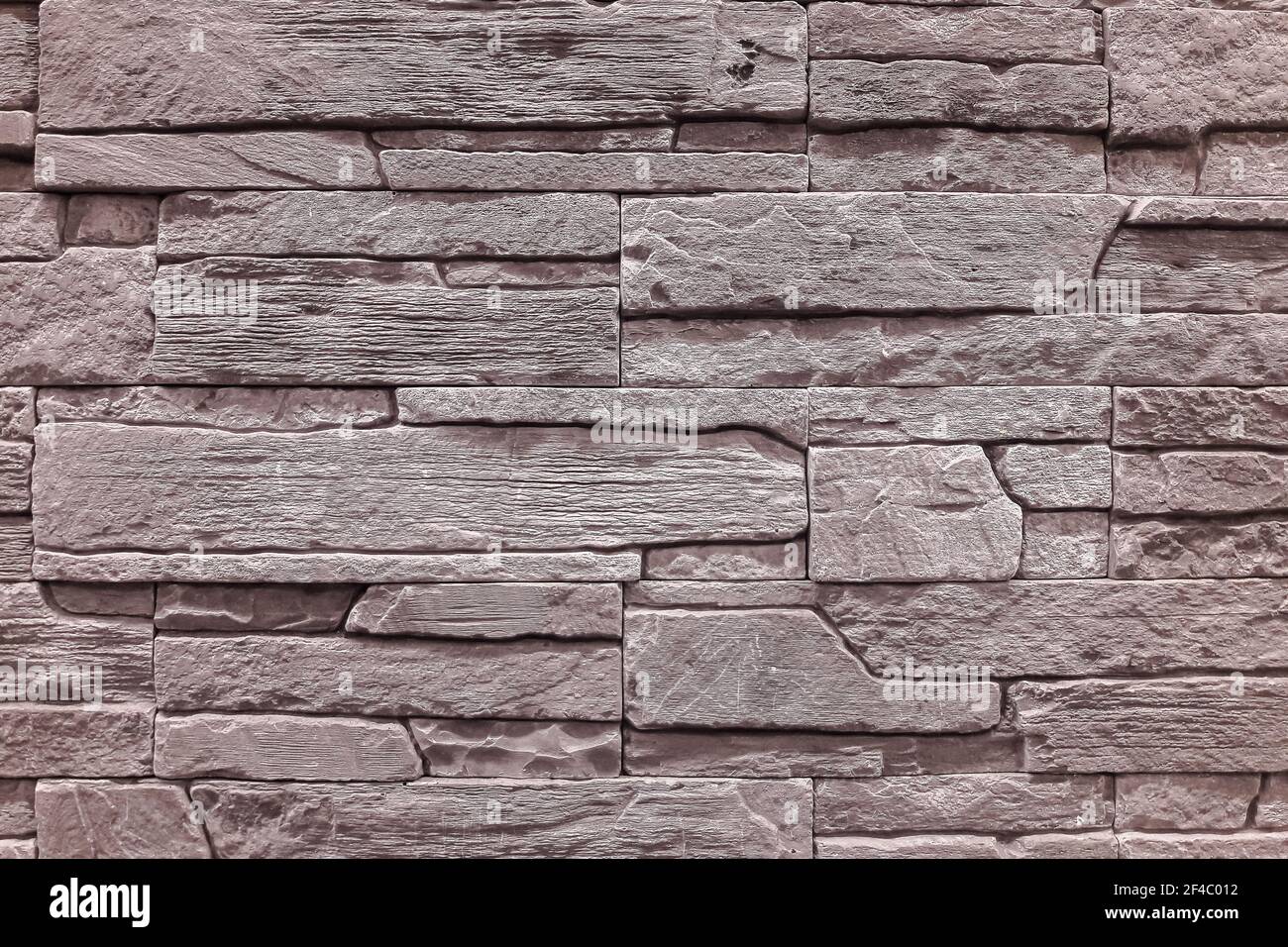 The wall is made of multi-layered natural stone. Stone for building a ...