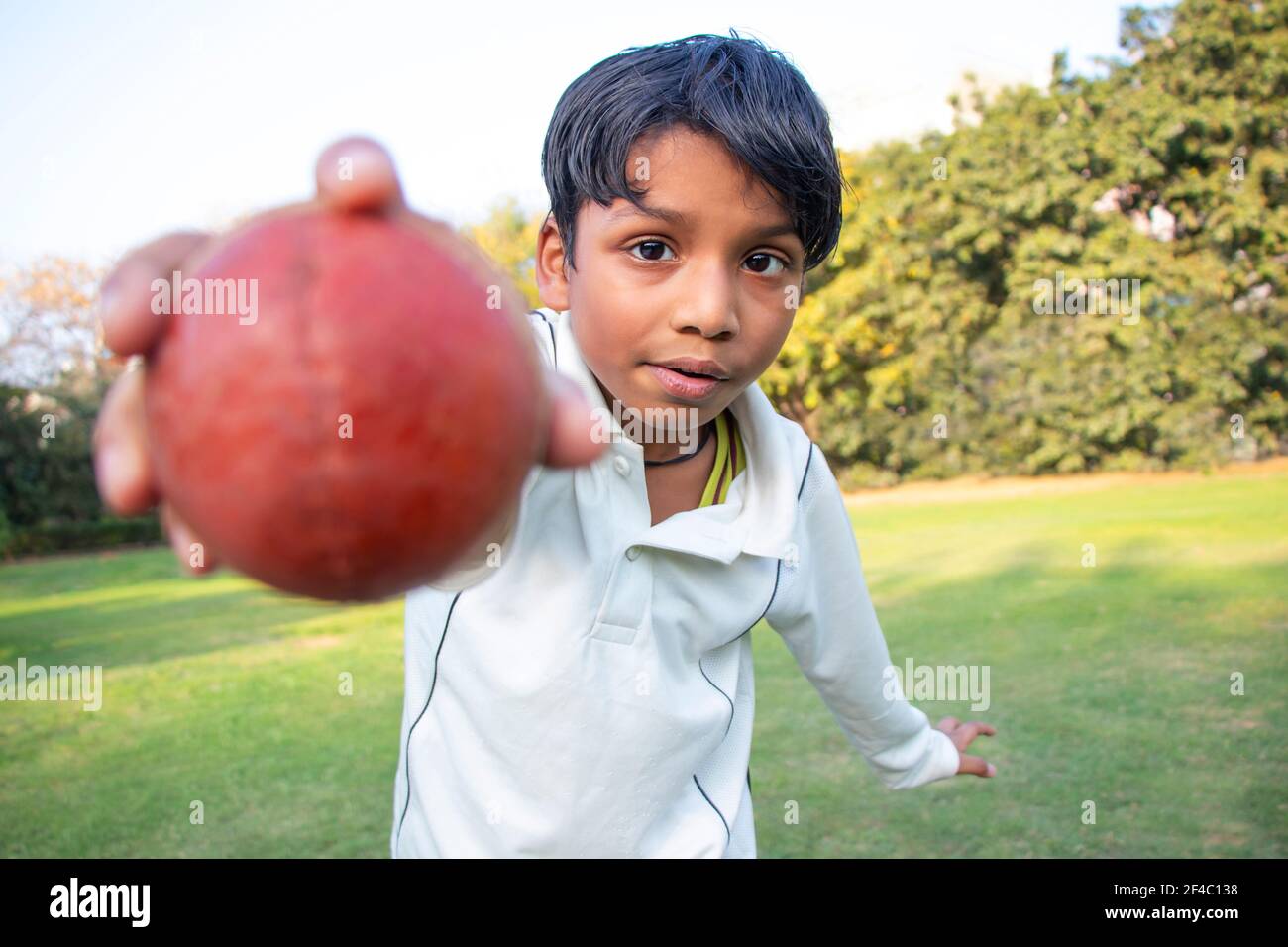 Young boy bowling leg spin in a cricket Stock Photo - Alamy