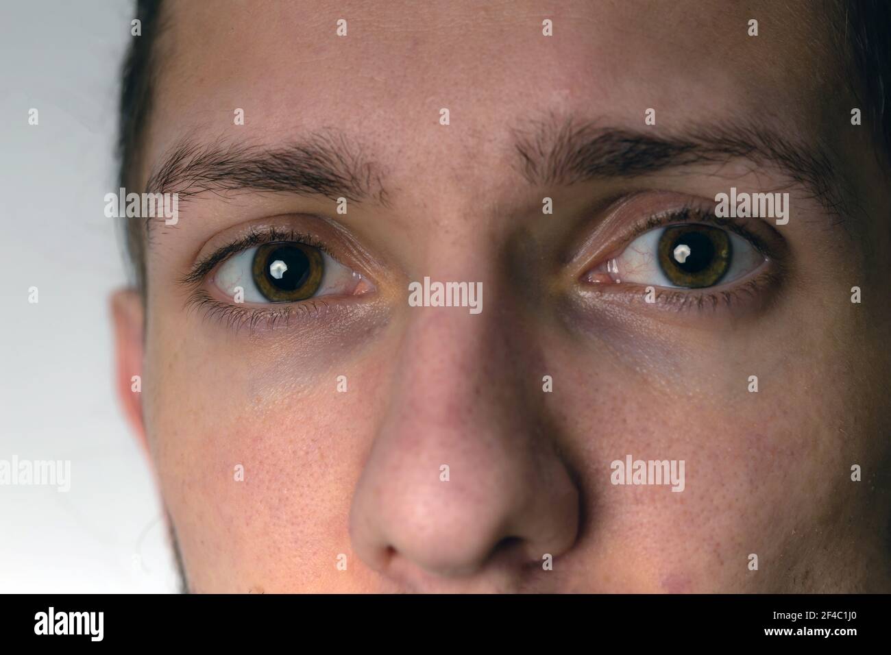 Close up of an unknown male focusing on his brown eyes Stock Photo - Alamy